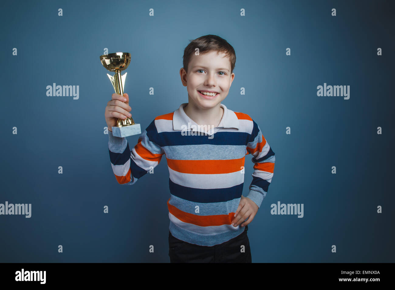teenager boy of about ten European appearance brown hair holding a cup ...