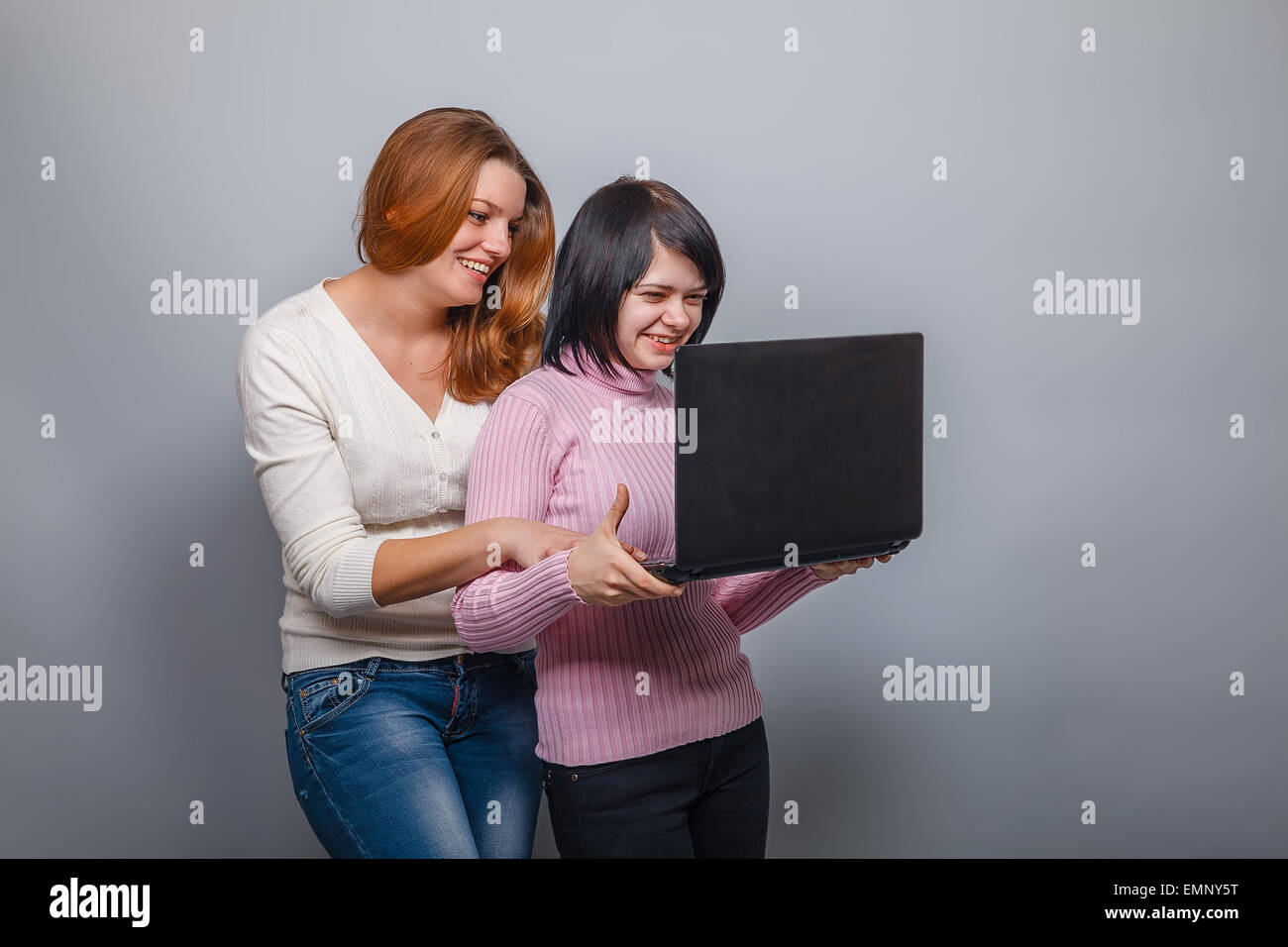 two girls European appearance girlfriend looking at the computer ...