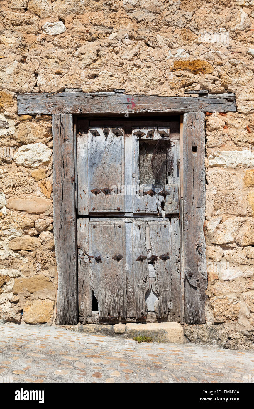 Rustic old wooden door in a masonry facade Stock Photo - Alamy