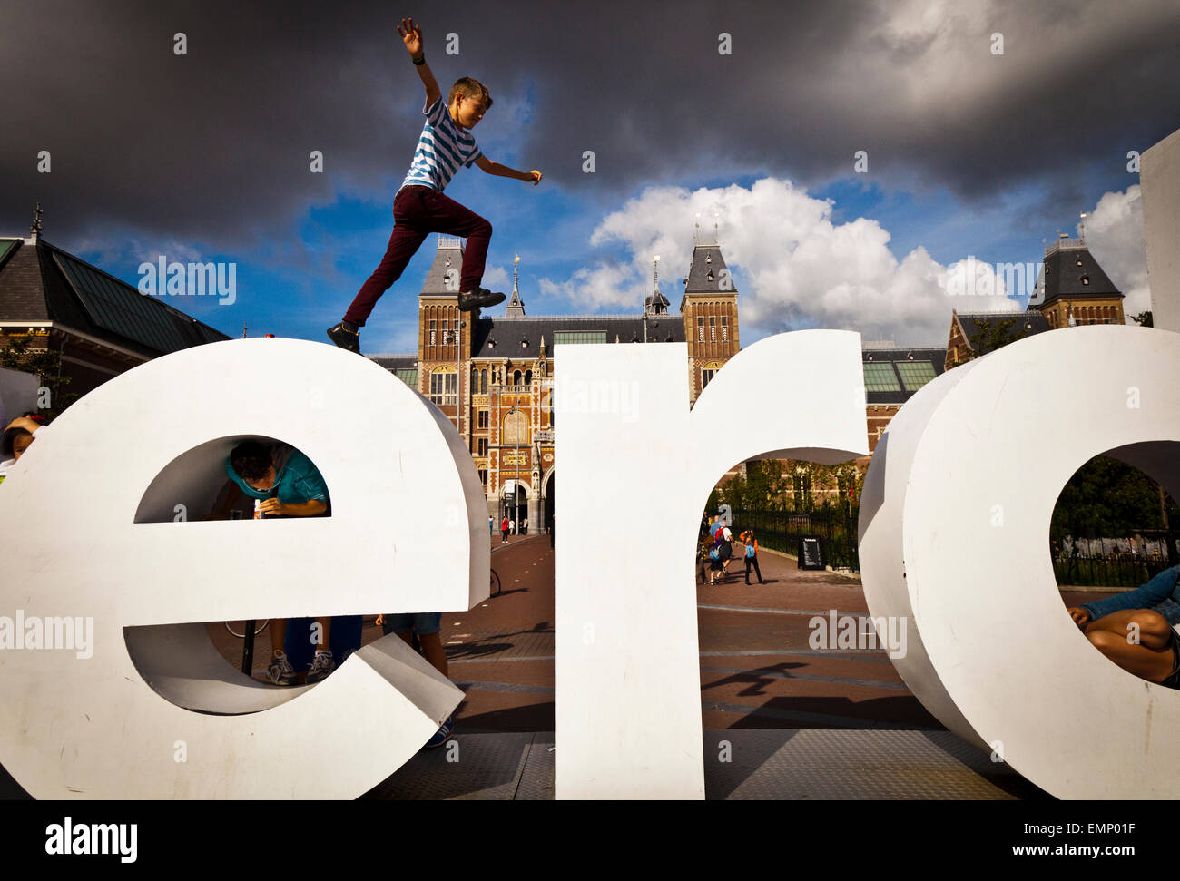 Young boy jumping on the I amsterdam logo in Amsterdam Stock Photo - Alamy