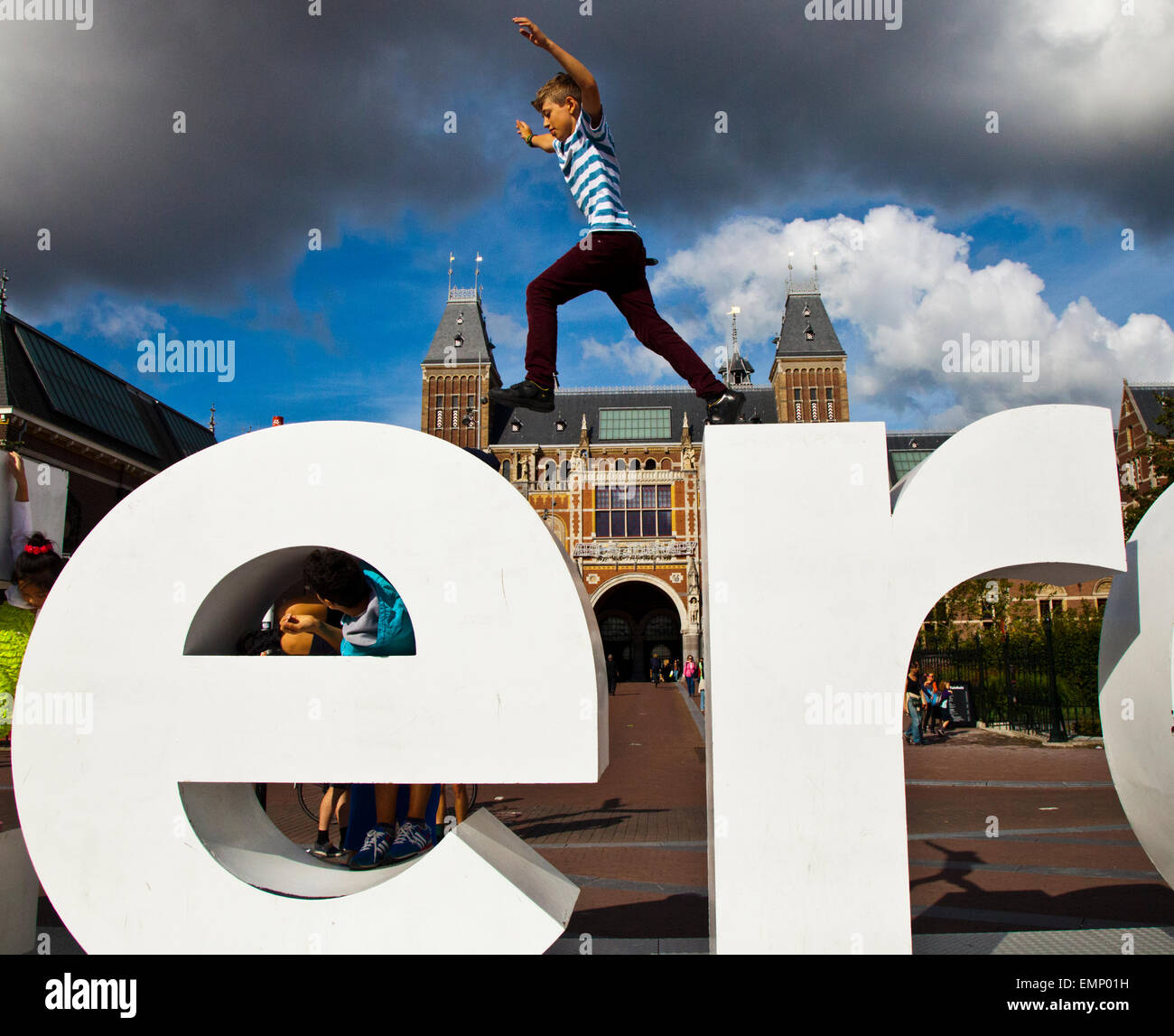 Young boy jumping on the I amsterdam logo in Amsterdam Stock Photo - Alamy