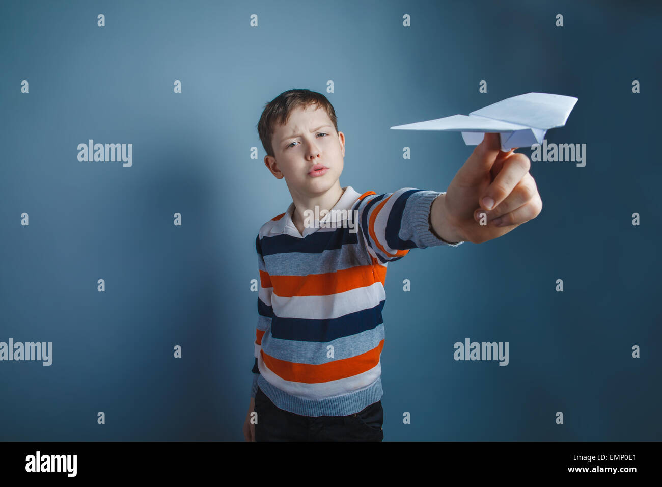 boy teenager European appearance Brown launches a paper airplane white ...