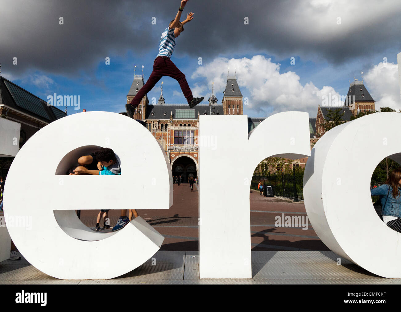 Young boy jumping on the I amsterdam logo in Amsterdam Stock Photo - Alamy
