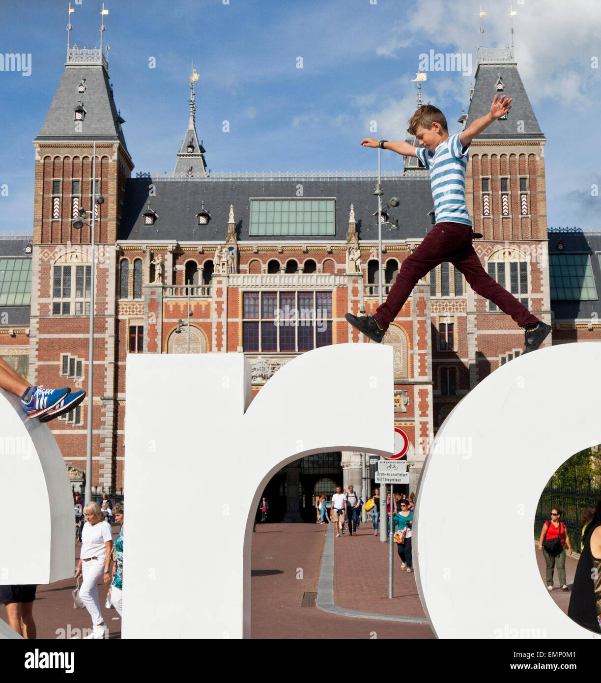 Young boy jumping on the I amsterdam logo in Amsterdam Stock Photo - Alamy