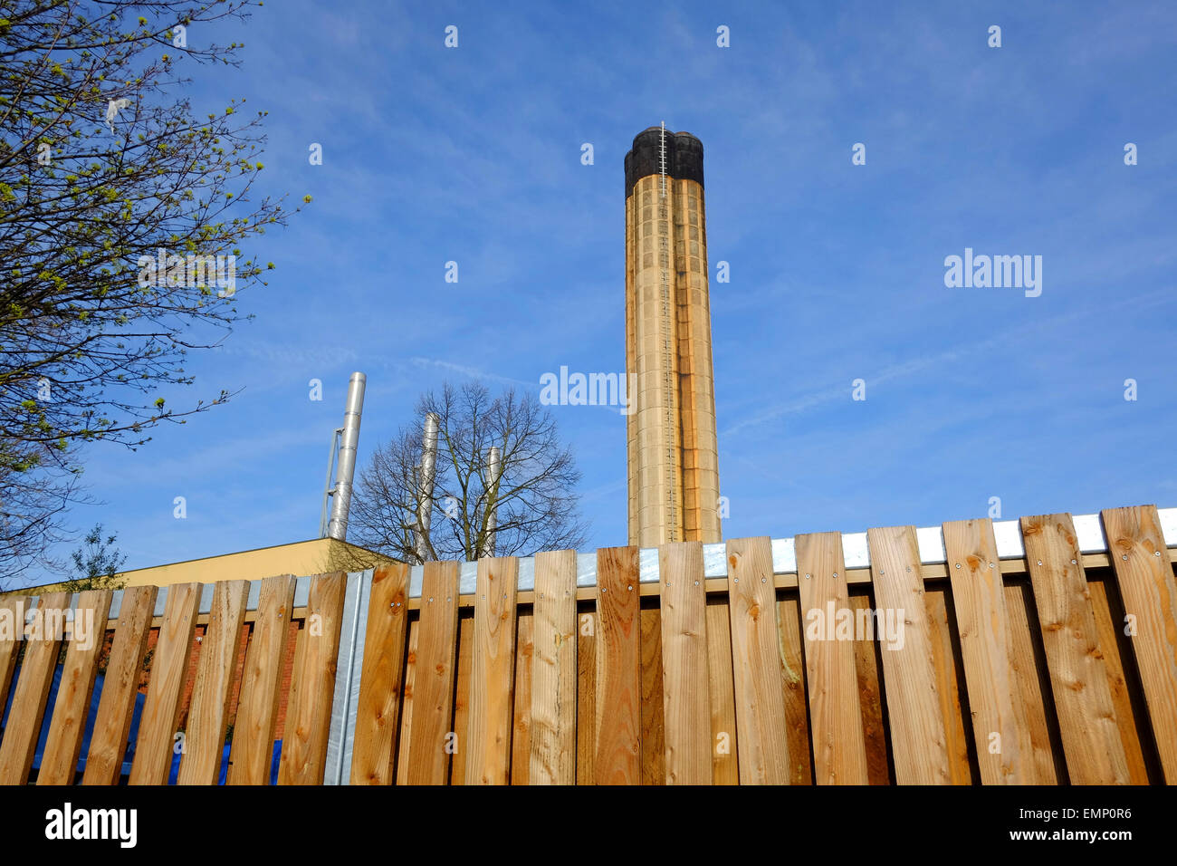 tall chimney behind wooden fence at Bedford Hospital Stock Photo - Alamy