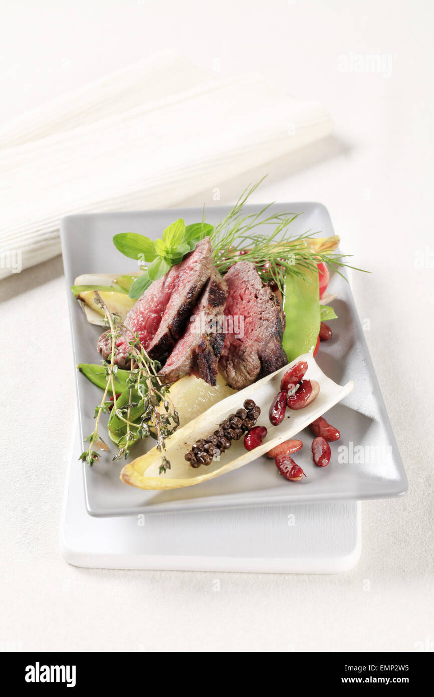 Slices of roast beef and vegetable garnish Stock Photo - Alamy