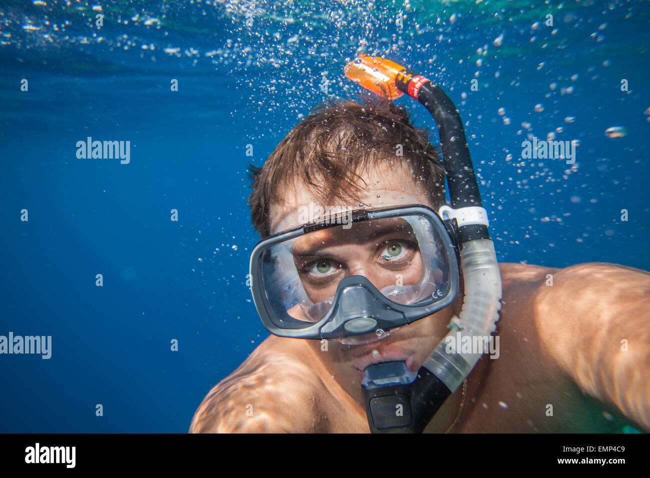 Man with mask snorkeling in clear water Stock Photo - Alamy