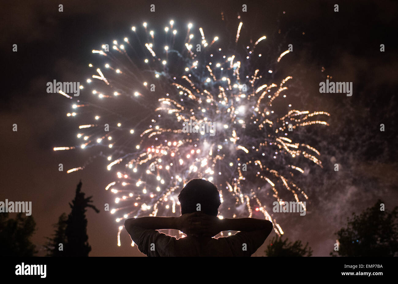 Jerusalem. 22nd Apr, 2015. A man watches fireworks during a celebration ...