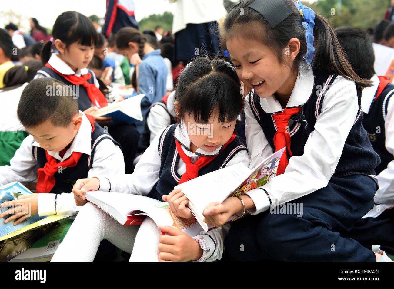 Nanning. 23rd Apr, 2015. Pupils read books at Binhulu Elementary School ...