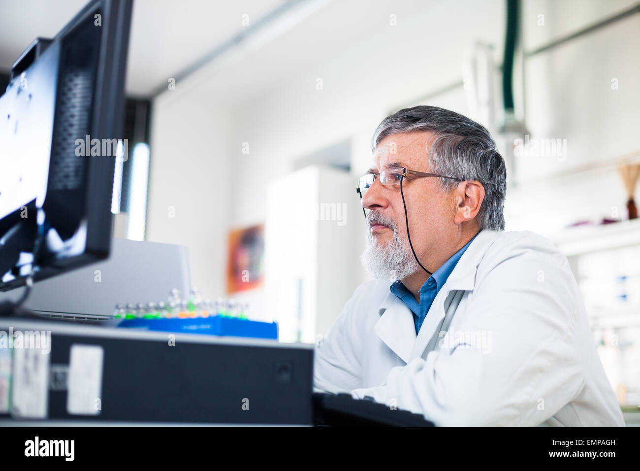 Senior researcher using a computer in the lab while working on an ...