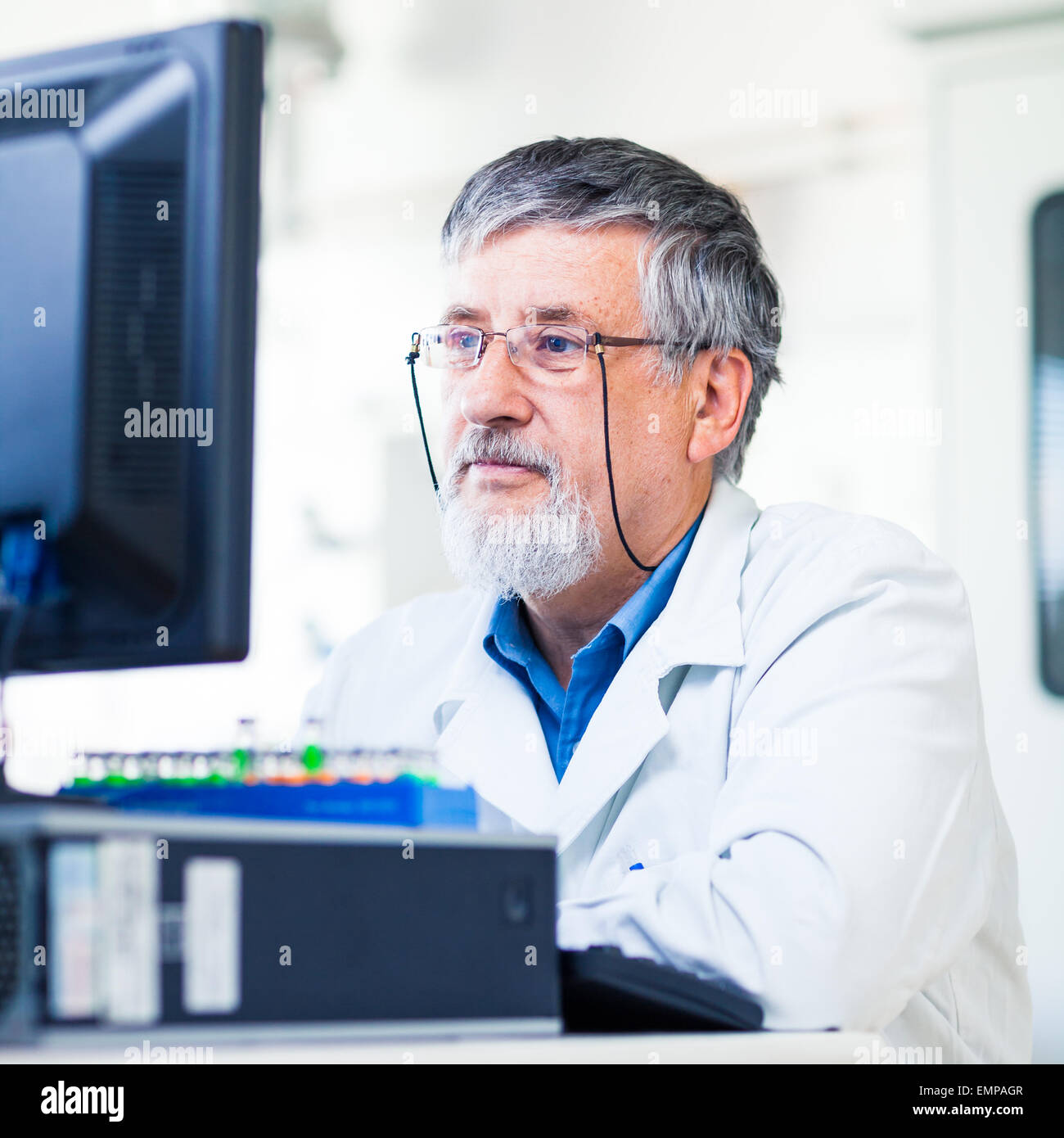 Senior researcher using a computer in the lab while working on an ...