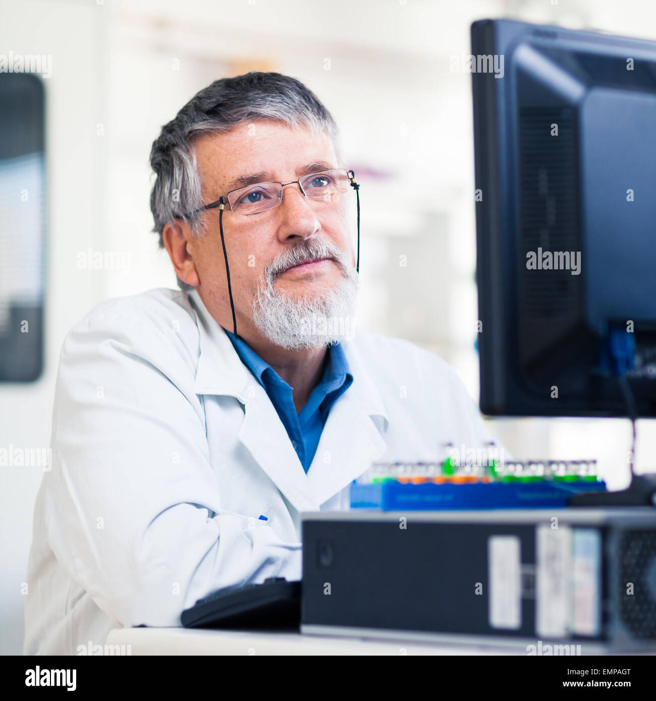 Senior researcher using a computer in the lab while working on an ...