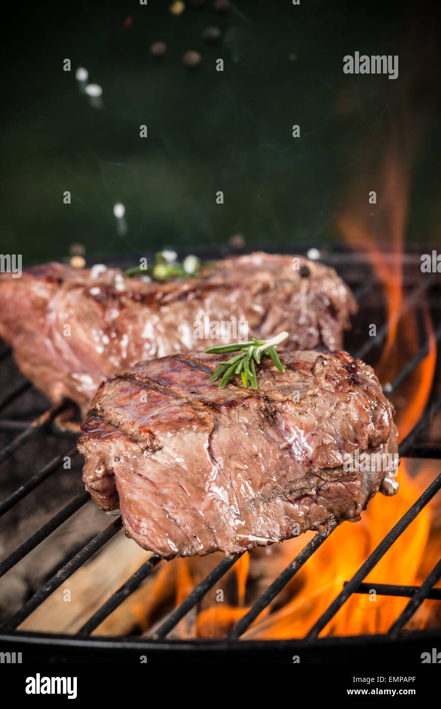 Beef steaks on grill Stock Photo - Alamy