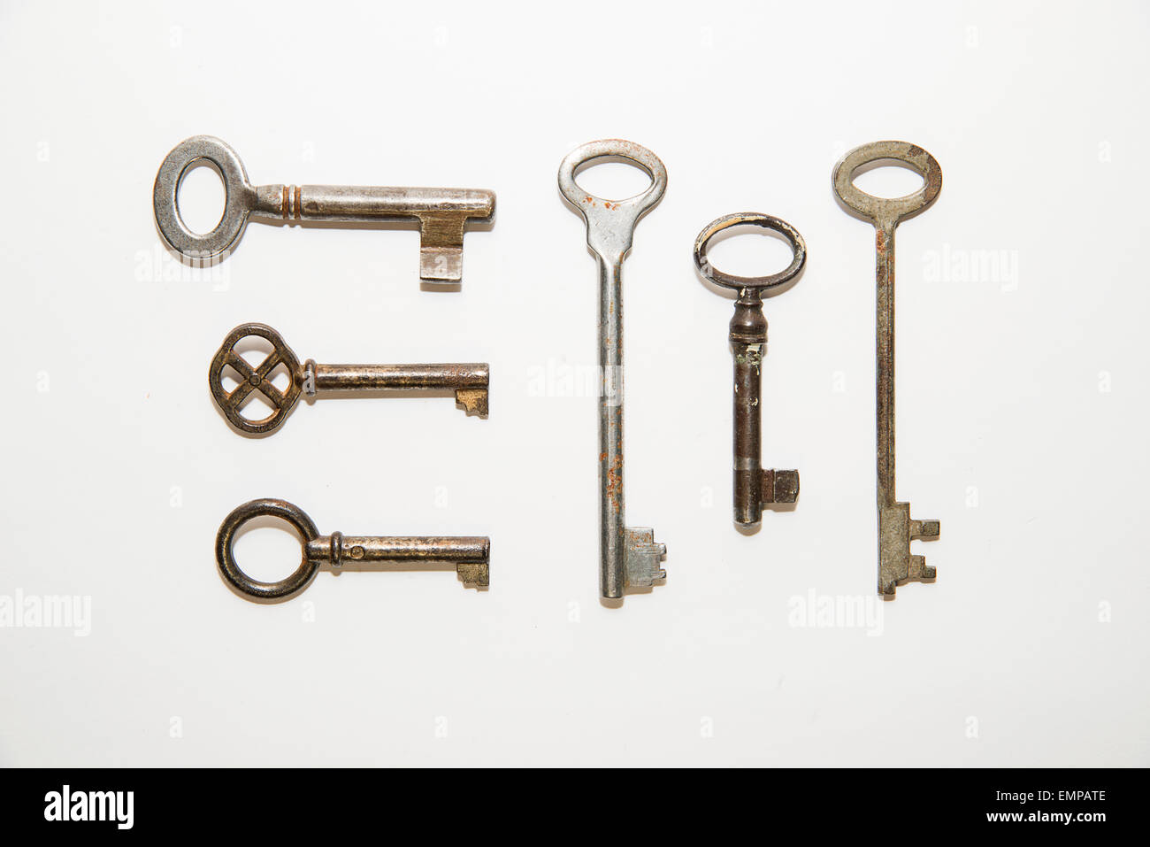 Six vintage keys to the safe on a white background Stock Photo - Alamy