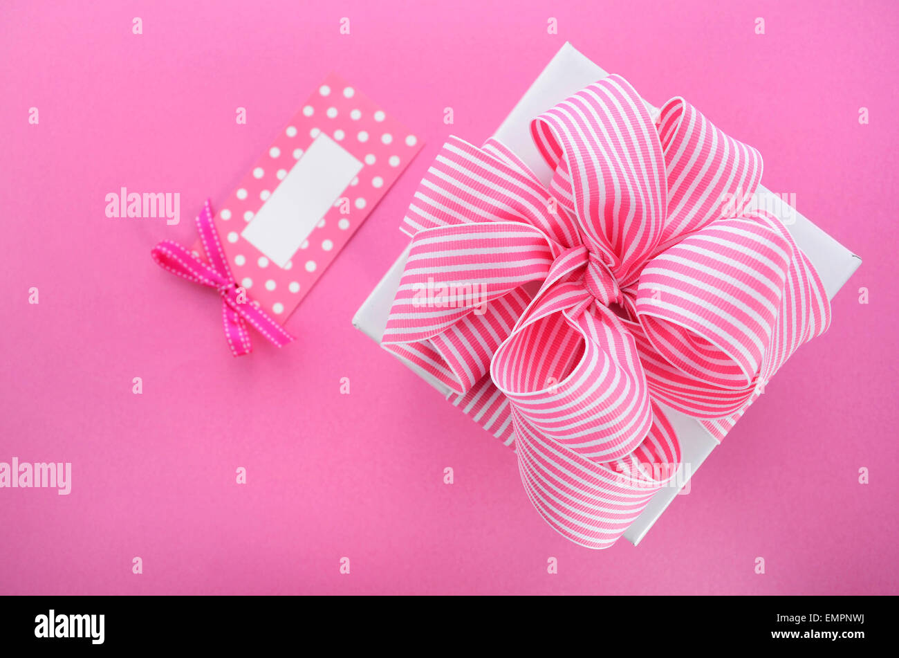 White gift box with pink stripe ribbon in modern pink and white ...