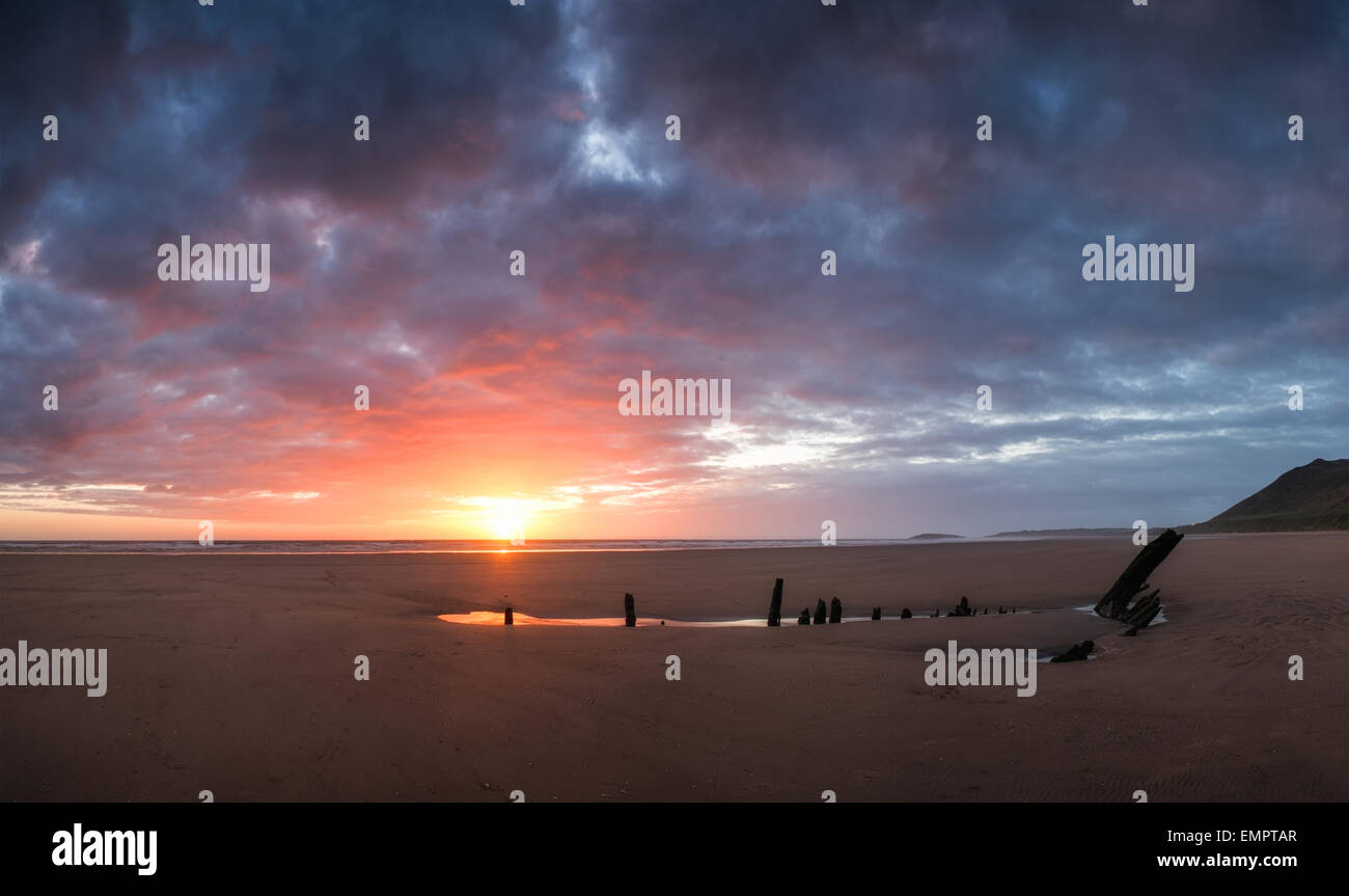 Landscape image of shipwreck on beach at sunset in Summer Stock Photo ...