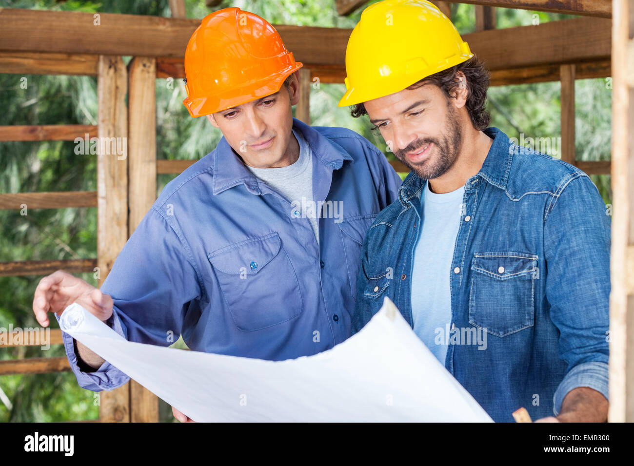 Architects Studying Blueprint At Site Stock Photo - Alamy