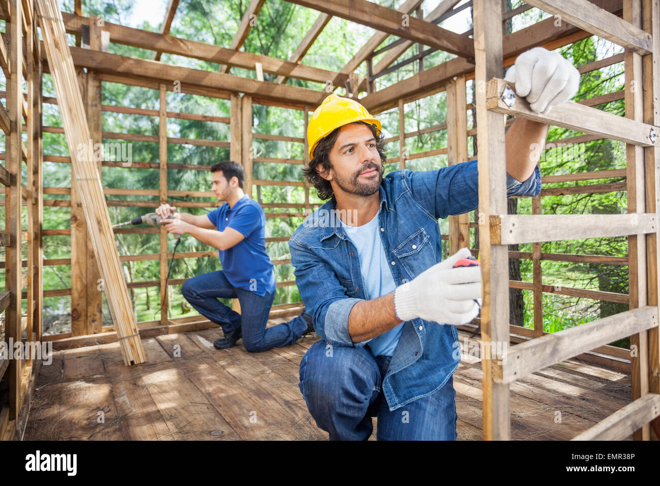 Construction Workers Working In Wooden Cabin Stock Photo - Alamy