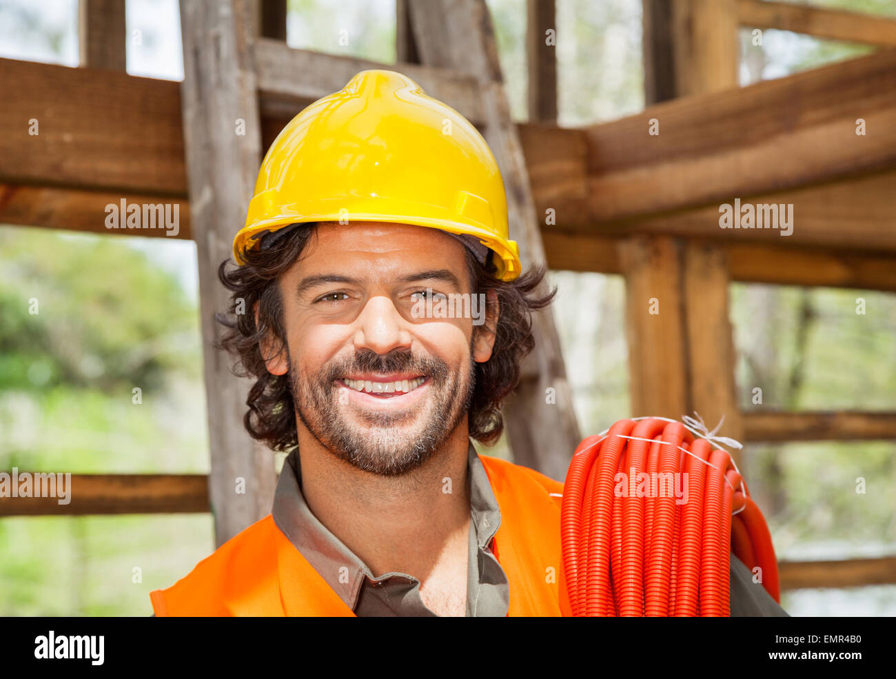 Happy Male Worker With Pipe At Construction Site Stock Photo - Alamy