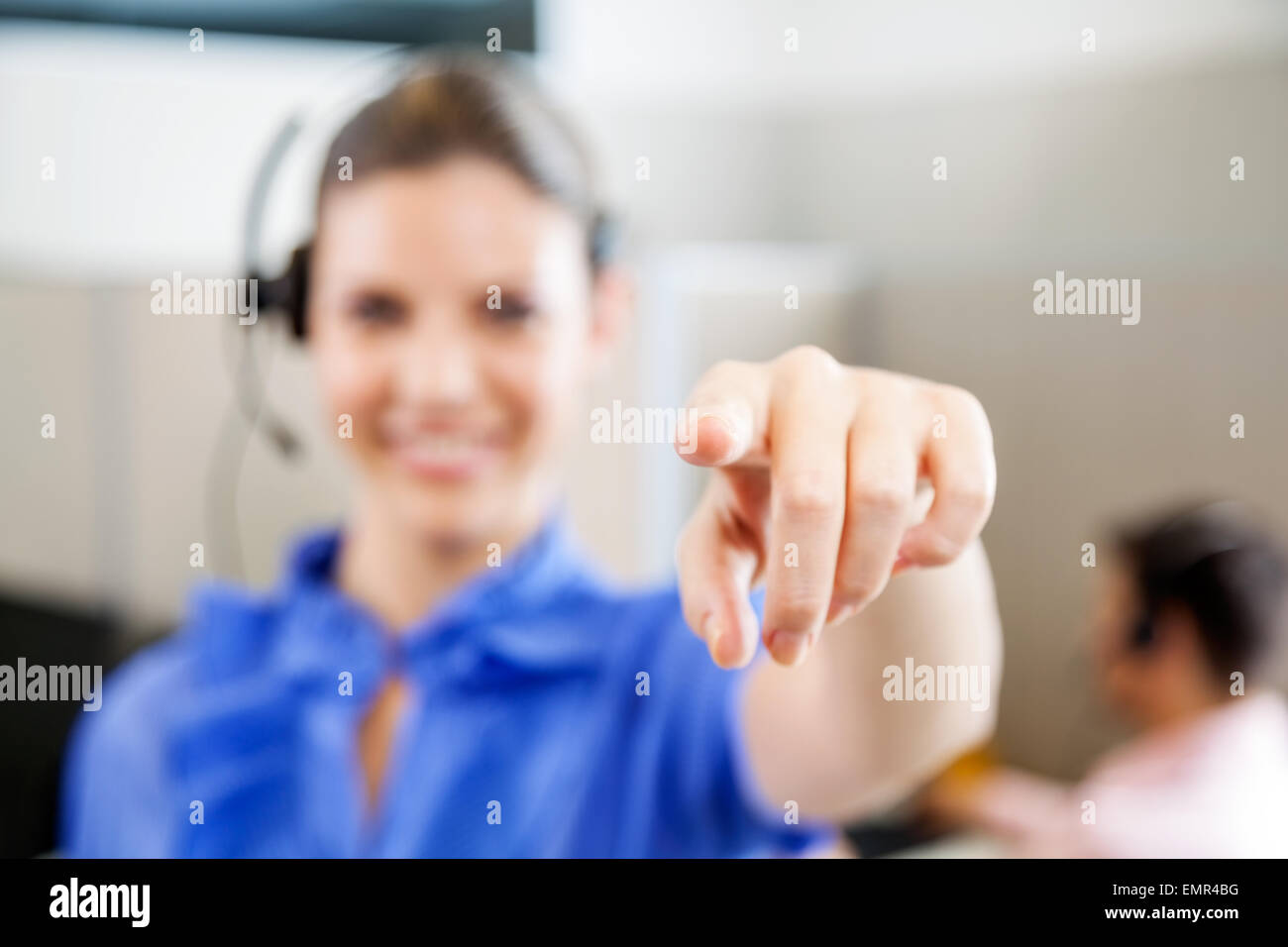 Customer Service Representative Pointing In Office Stock Photo - Alamy
