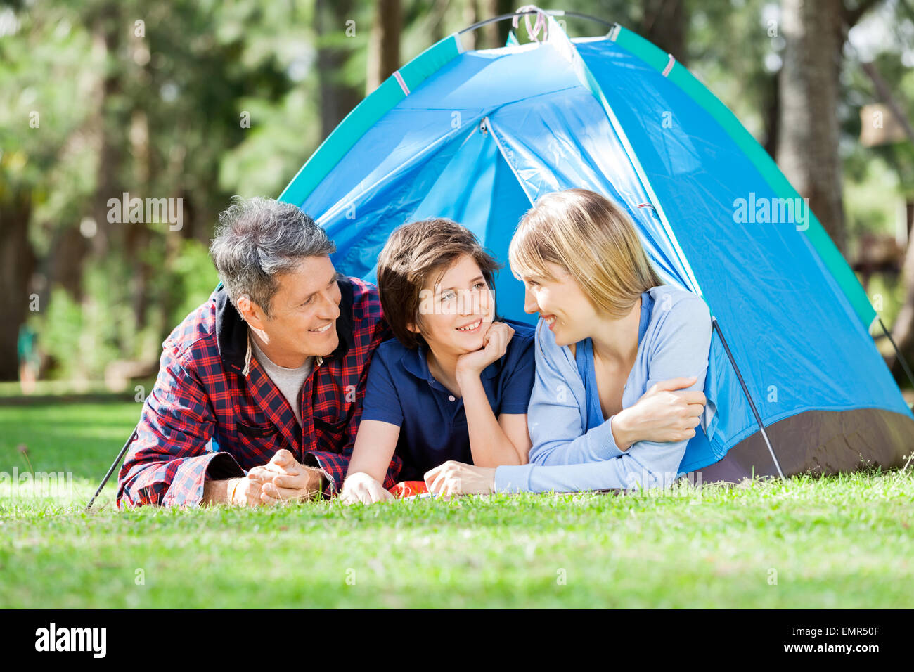 Smiling Family Camping In Park Stock Photo - Alamy