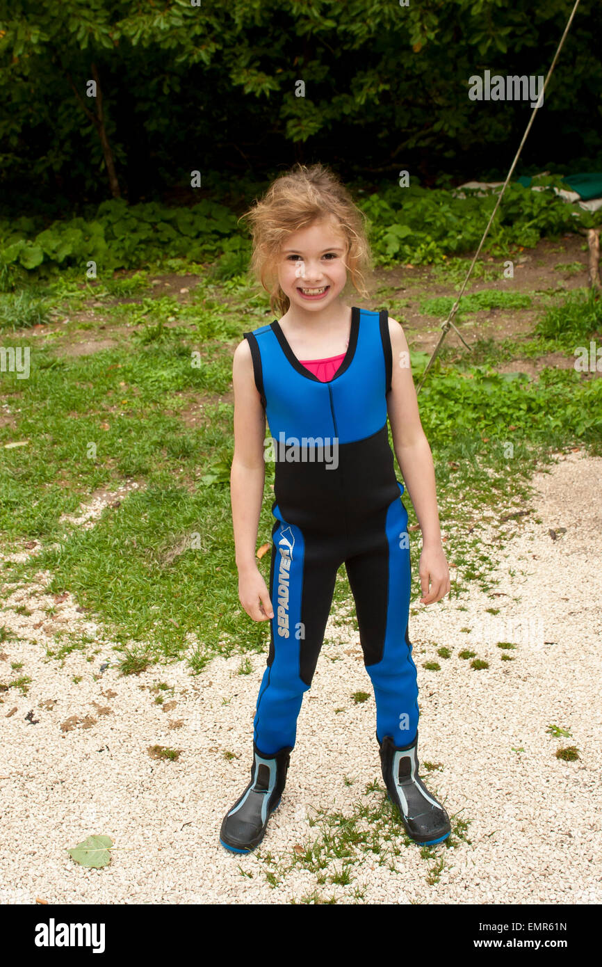 young girl wearing a wetsuit as she prepares to go rafting in Umbria ...