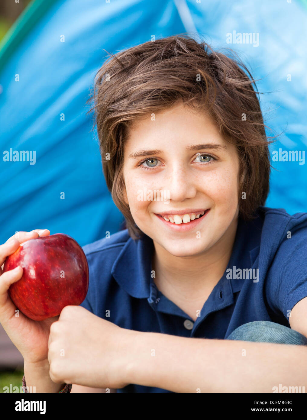 Boy Holding Apple At Campsite Stock Photo - Alamy