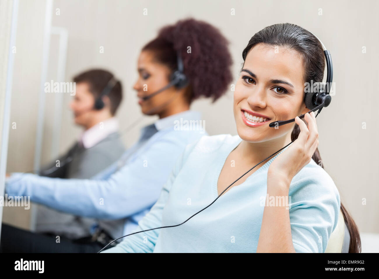 Smiling Female Customer Service Agent In Office Stock Photo - Alamy