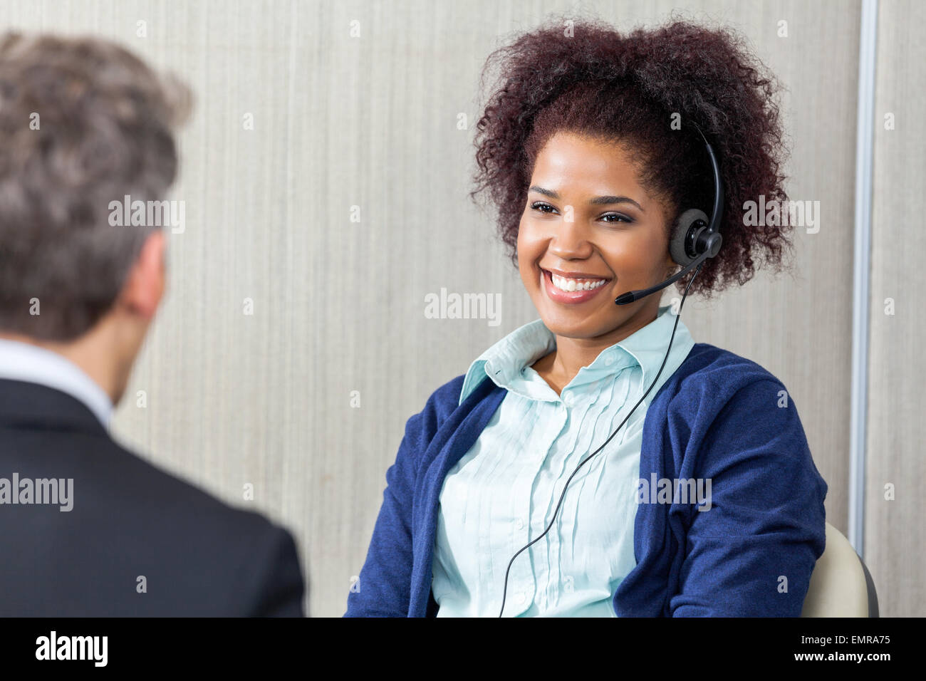 Happy Female Customer Service Agent Looking At Manager Stock Photo - Alamy