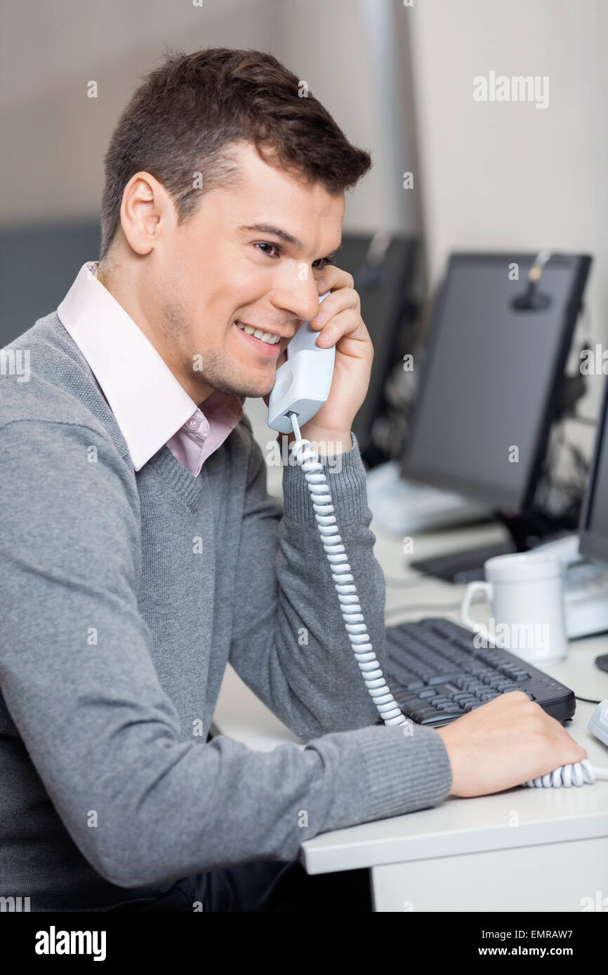 Customer Service Representative Using Landline Phone At Desk Stock ...
