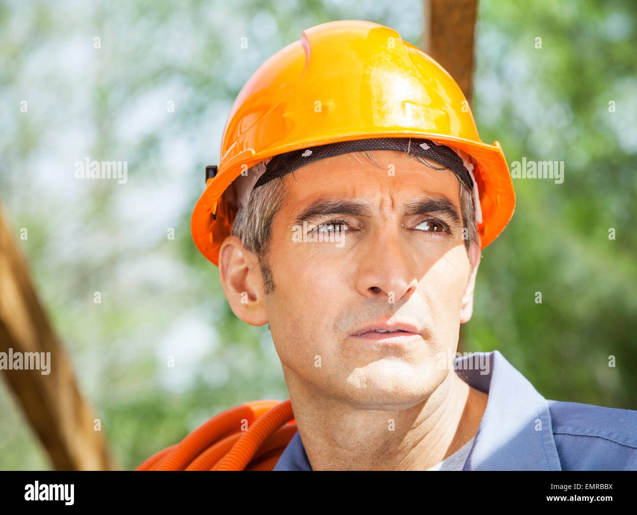 Thoughtful Construction Worker Looking Away Stock Photo - Alamy