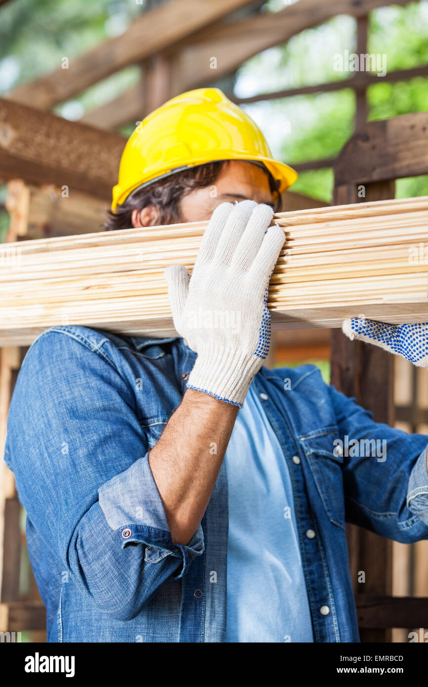 Man carrying planks of wood hi-res stock photography and images - Alamy