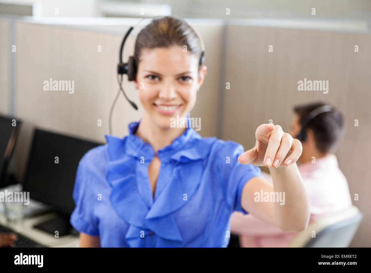 Smiling Call Center Employee Pointing In Office Stock Photo - Alamy
