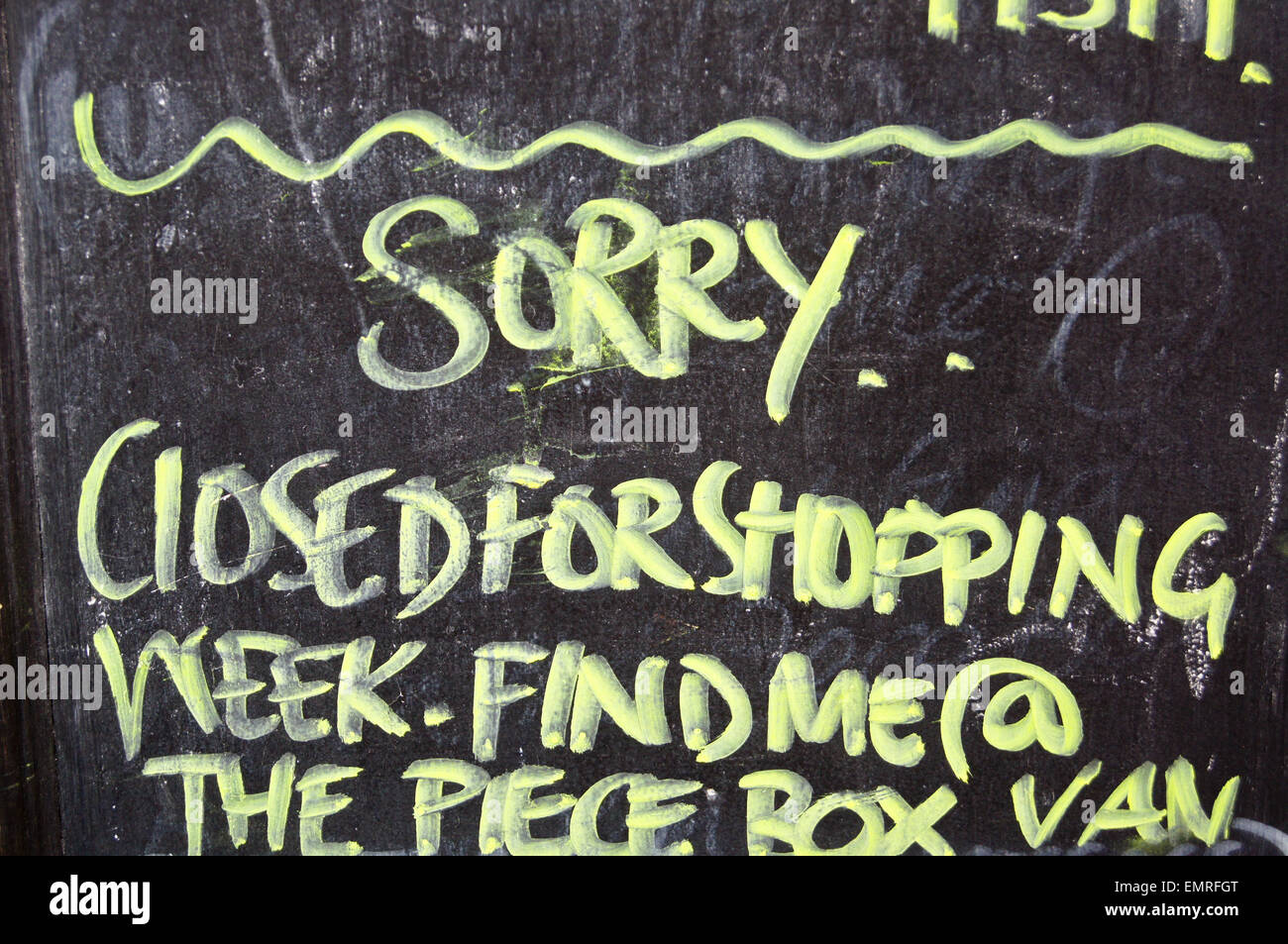Chalk sign on a blackboard with the message "Closed for shopping week ...