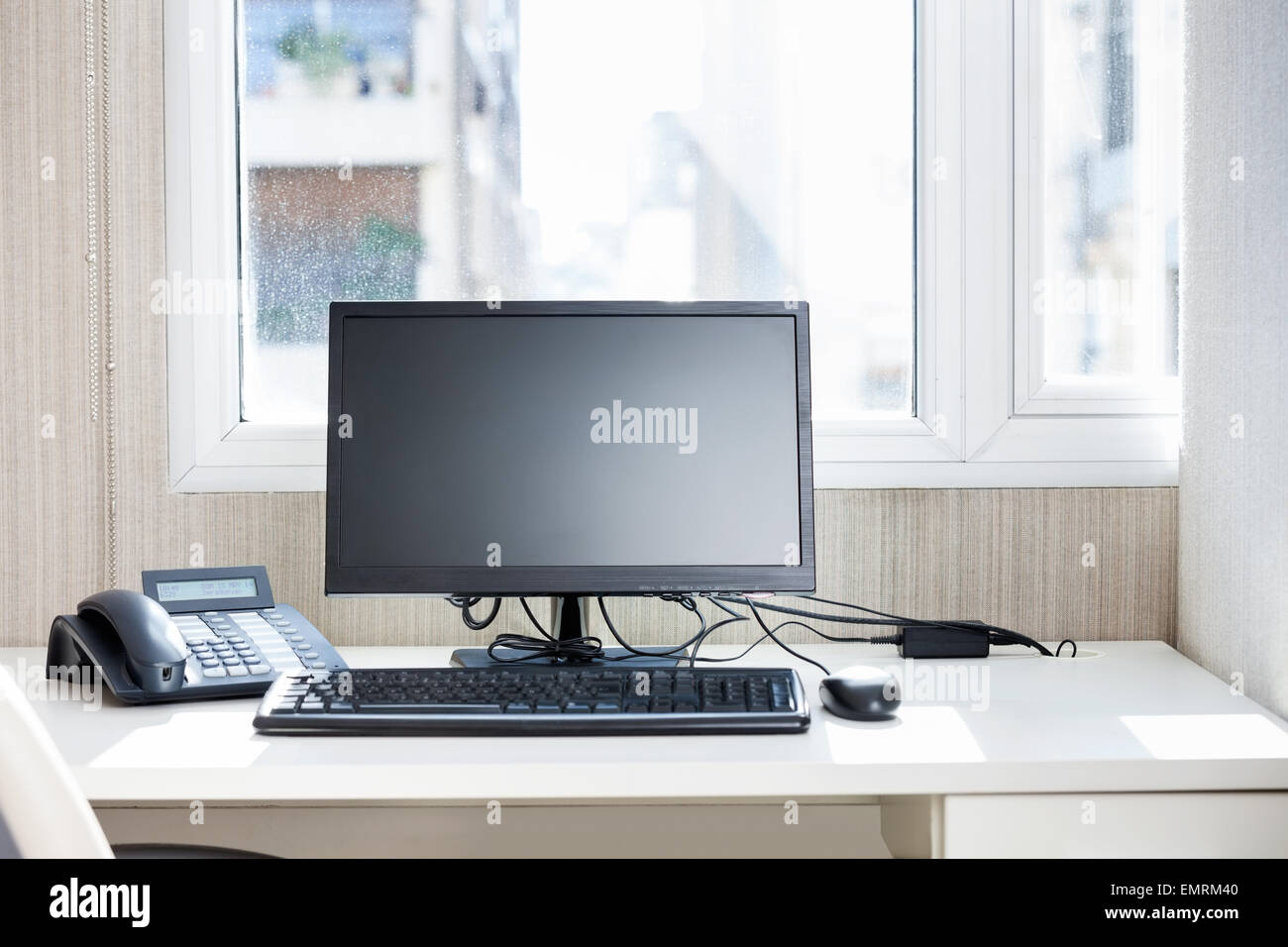 Computer And Landline Phone On Desk Stock Photo - Alamy