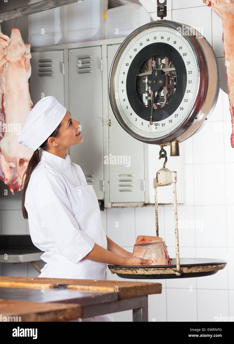Female Butcher Weighing Meat In Butchery Stock Photo - Alamy