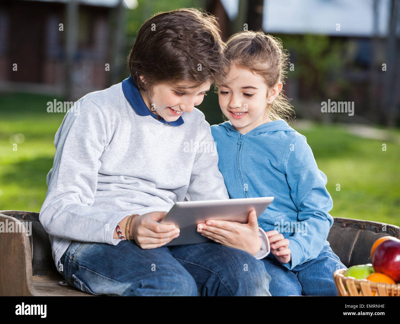 Happy siblings using digital tablet hi-res stock photography and images ...