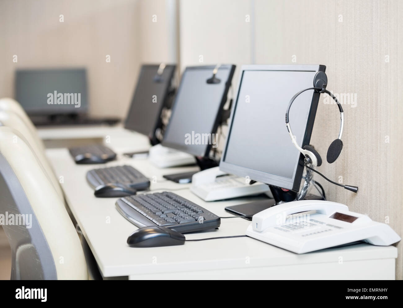 Computers With Headphones At Workplace Stock Photo - Alamy