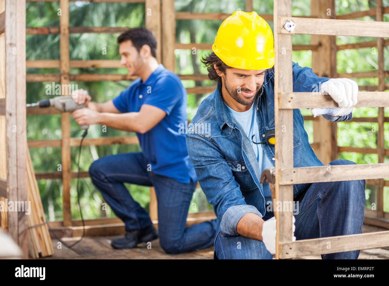 Workers Working In Wooden Cabin At Site Stock Photo - Alamy