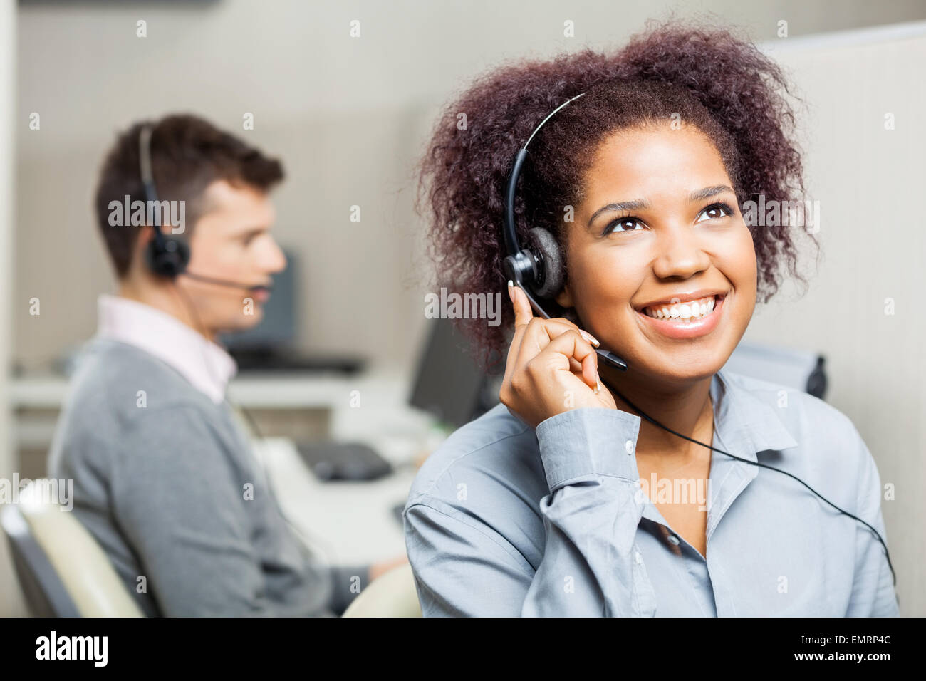 Happy Female Call Center Agent Using Headset In Call Center Stock Photo - Alamy