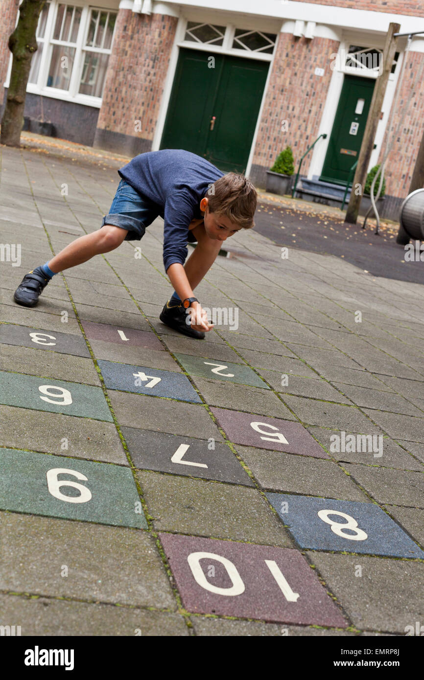 A young boy plays hopscotch in Amsterdam Holland The Netherlands Europe ...