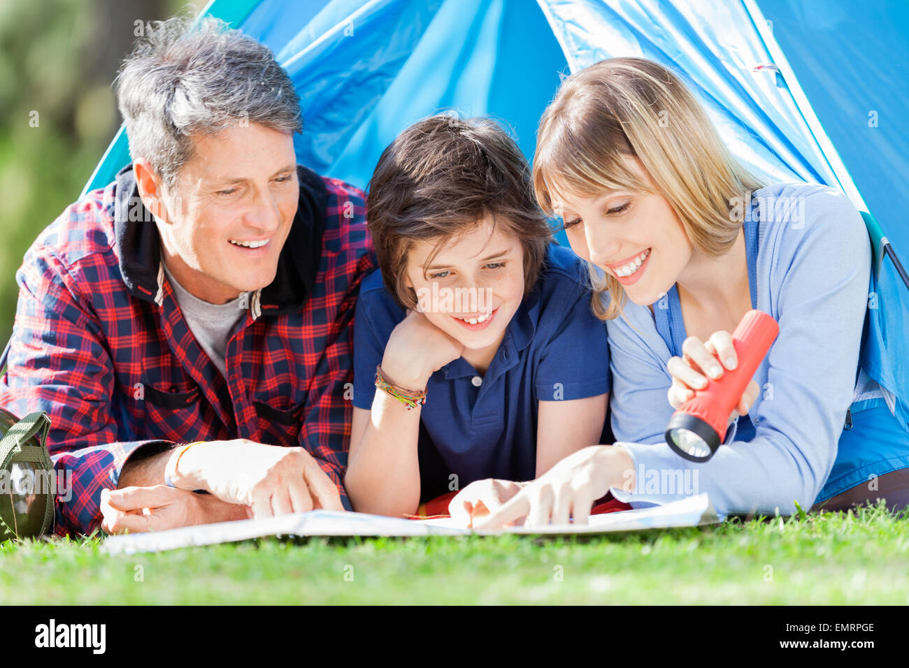 Family Looking At Map In Tent Stock Photo - Alamy