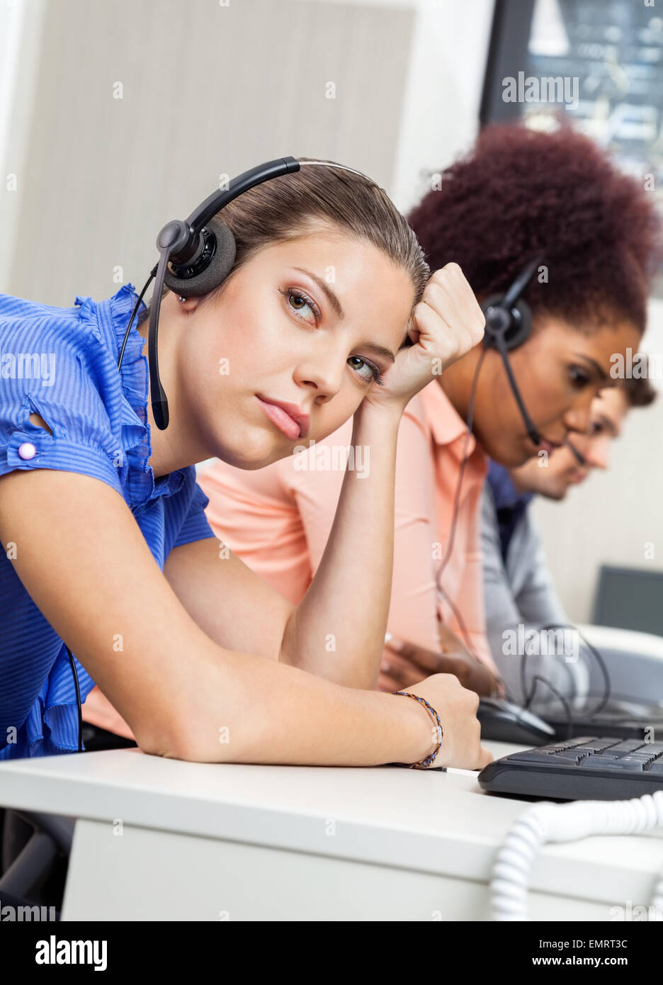Tired Customer Service Representative In Office Stock Photo - Alamy