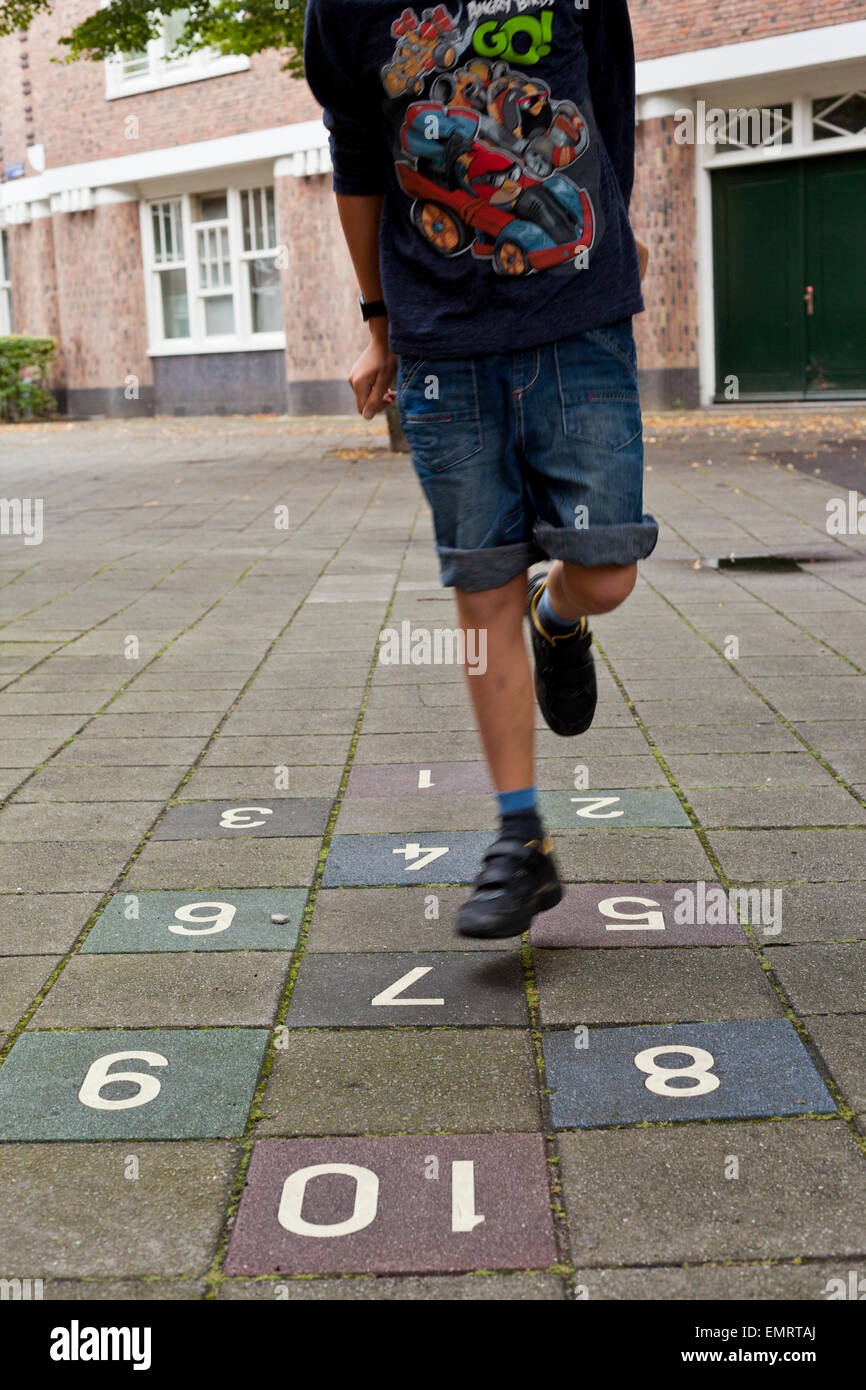 A young boy plays hopscotch in Amsterdam Holland The Netherlands Europe ...