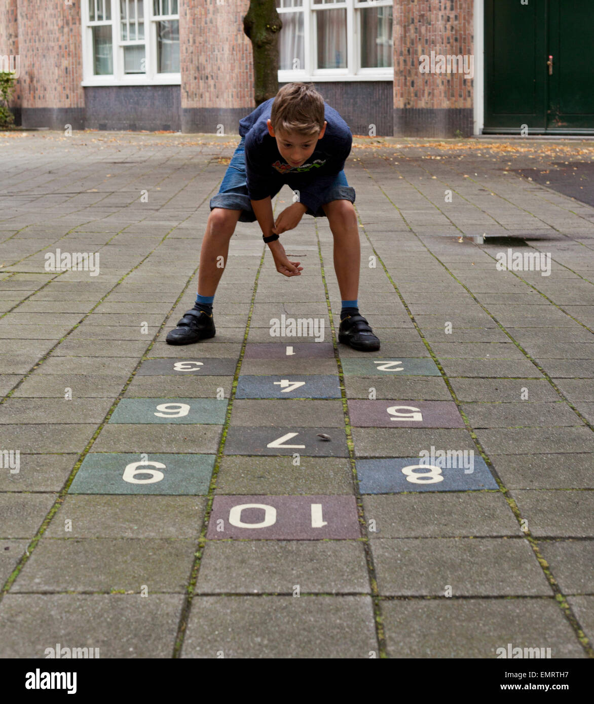 A young boy plays hopscotch in Amsterdam Holland The Netherlands Europe ...