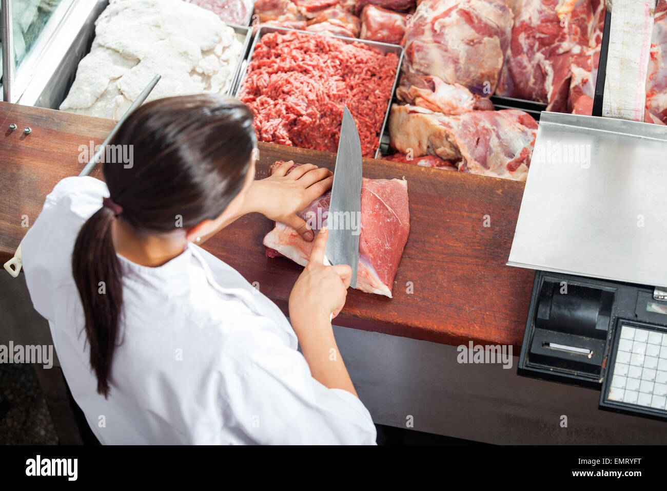 Female Butcher Cutting Red Meat Stock Photo - Alamy