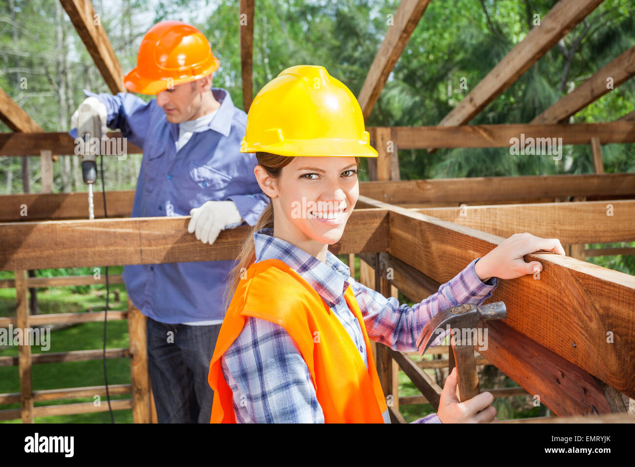 Workers Working In Timber Frame At Site Stock Photo - Alamy