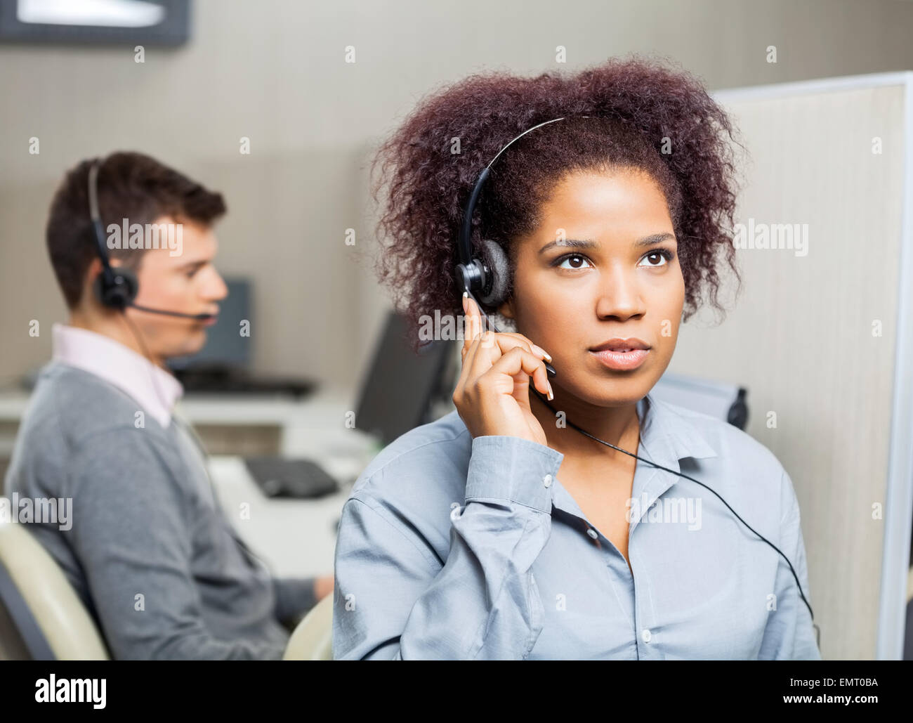 Female Customer Service Representative Using Headphones Stock Photo - Alamy