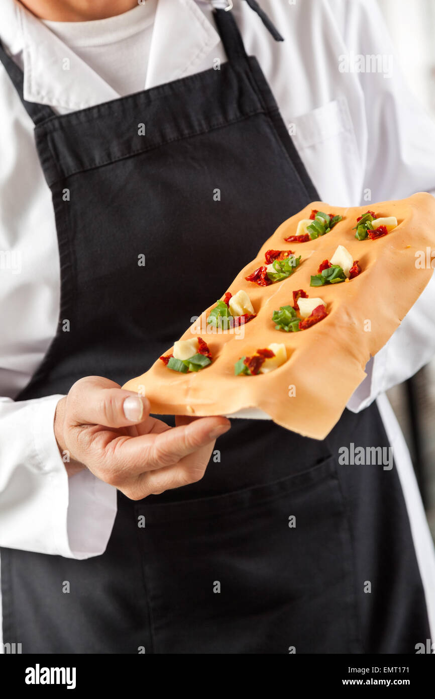 Male Chef Holding Tray With Stuffed Ravioli Pasta Sheet Stock Photo - Alamy