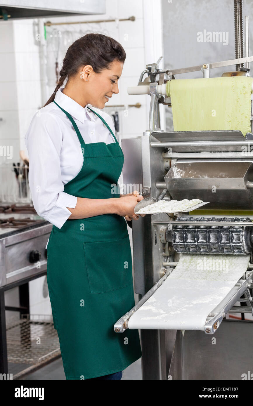 Female Chef Processing Ravioli Pasta In Machine Stock Photo - Alamy